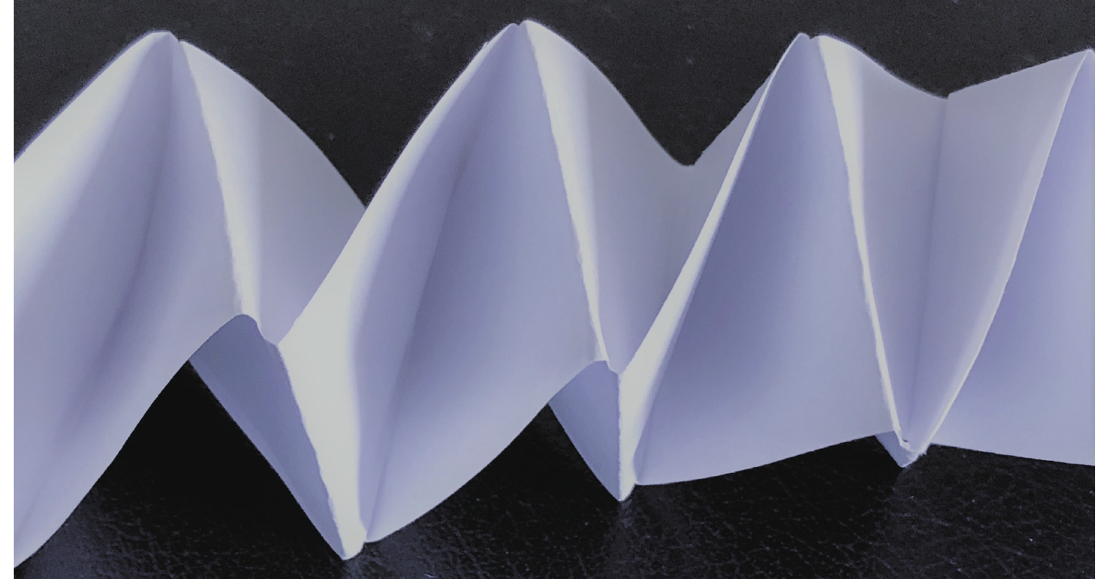 Universal scaling law of an origami paper spring